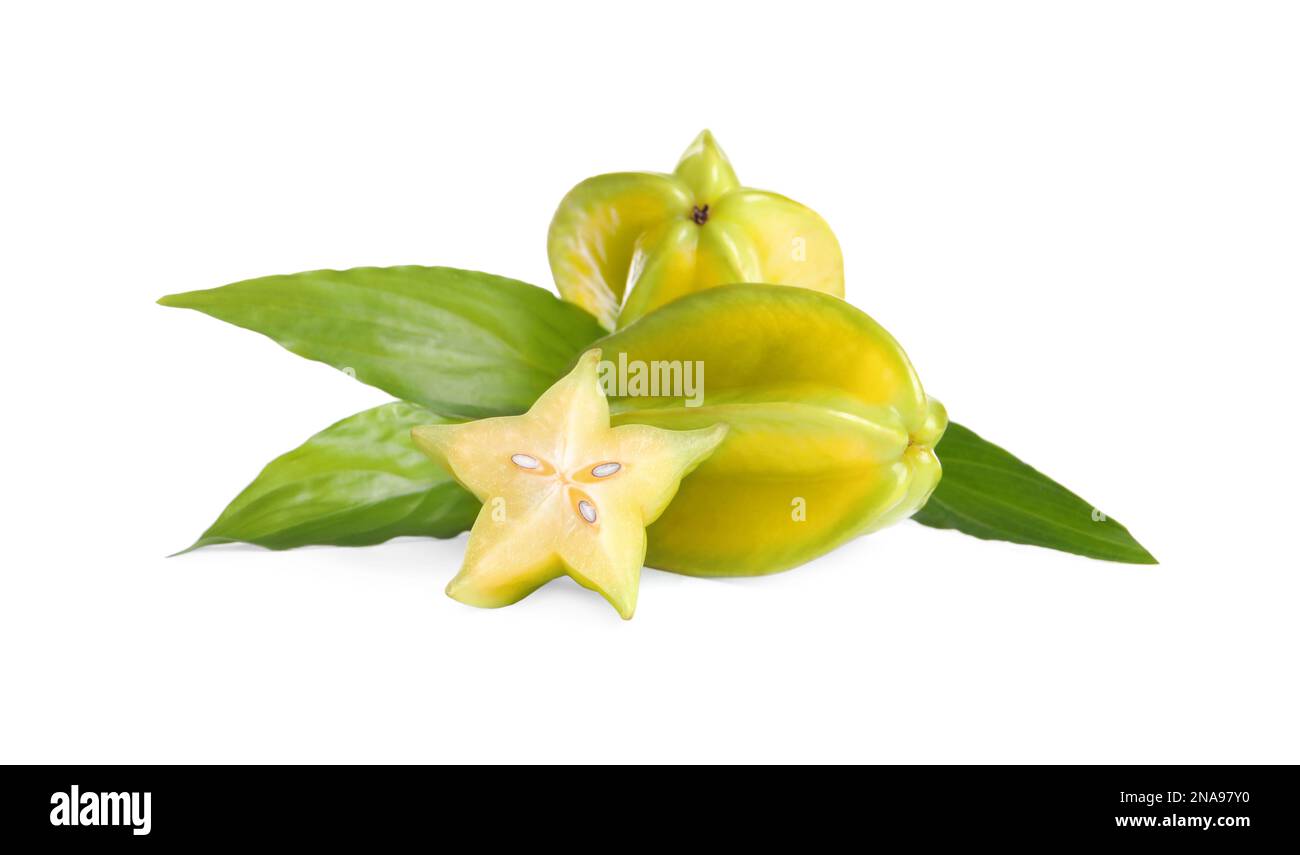 Cut and whole carambolas with green leaves on white background Stock ...