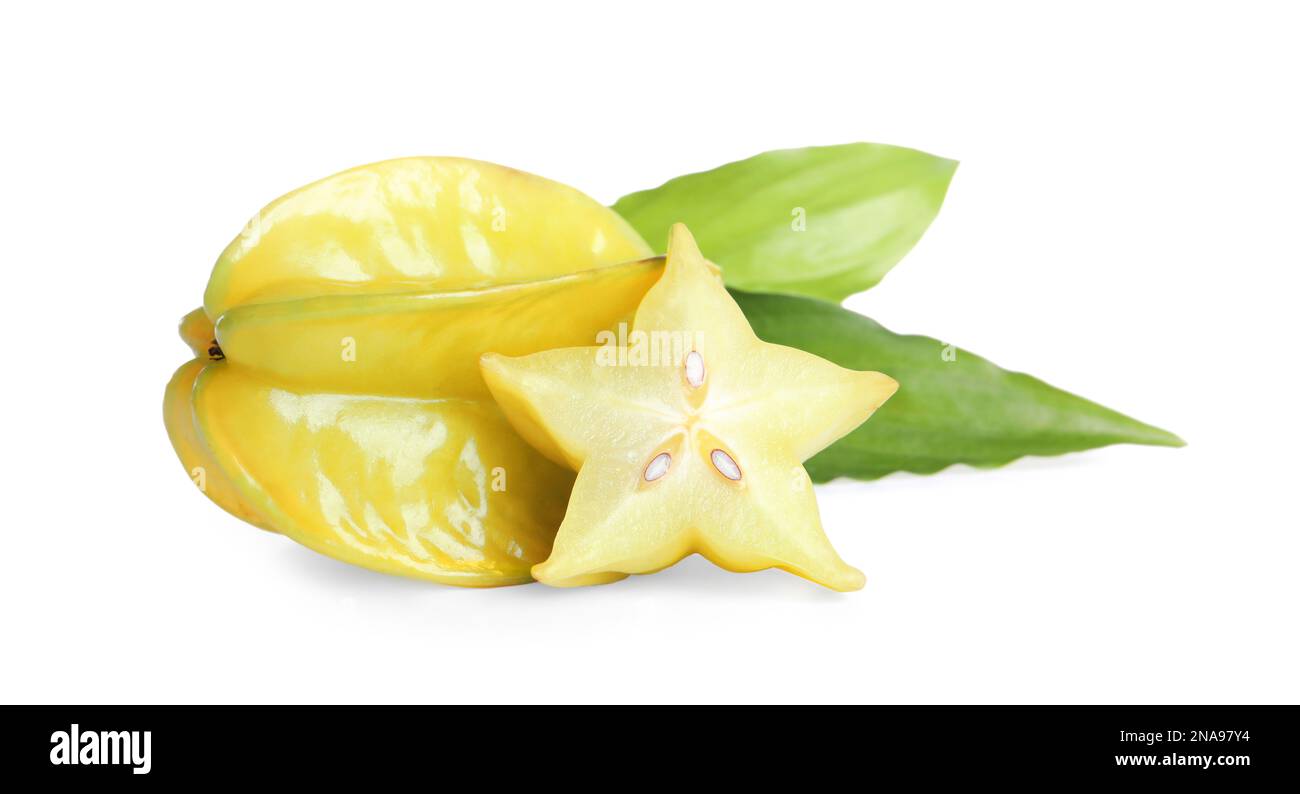 Cut and whole carambolas with green leaves on white background Stock ...