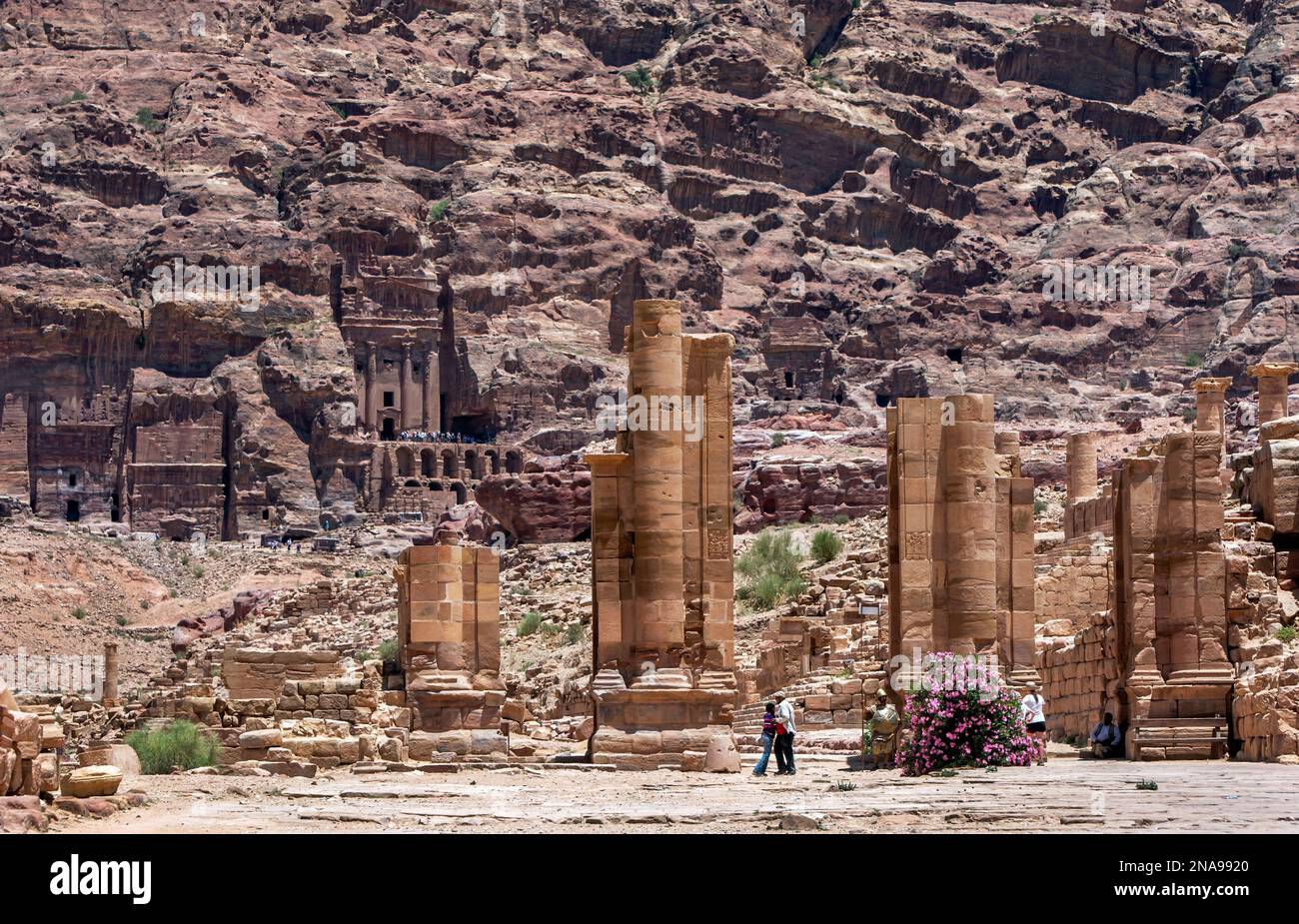 Tourists stand adjacent to the ruins of the Arched Gate at the ancient ...