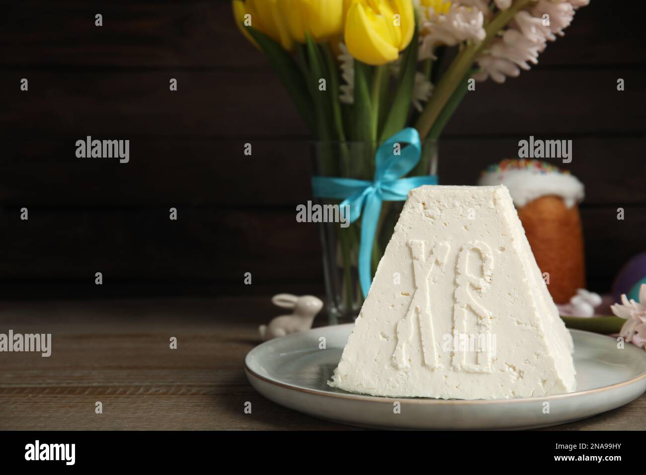 Traditional cottage cheese Easter paskha on wooden table, space for ...