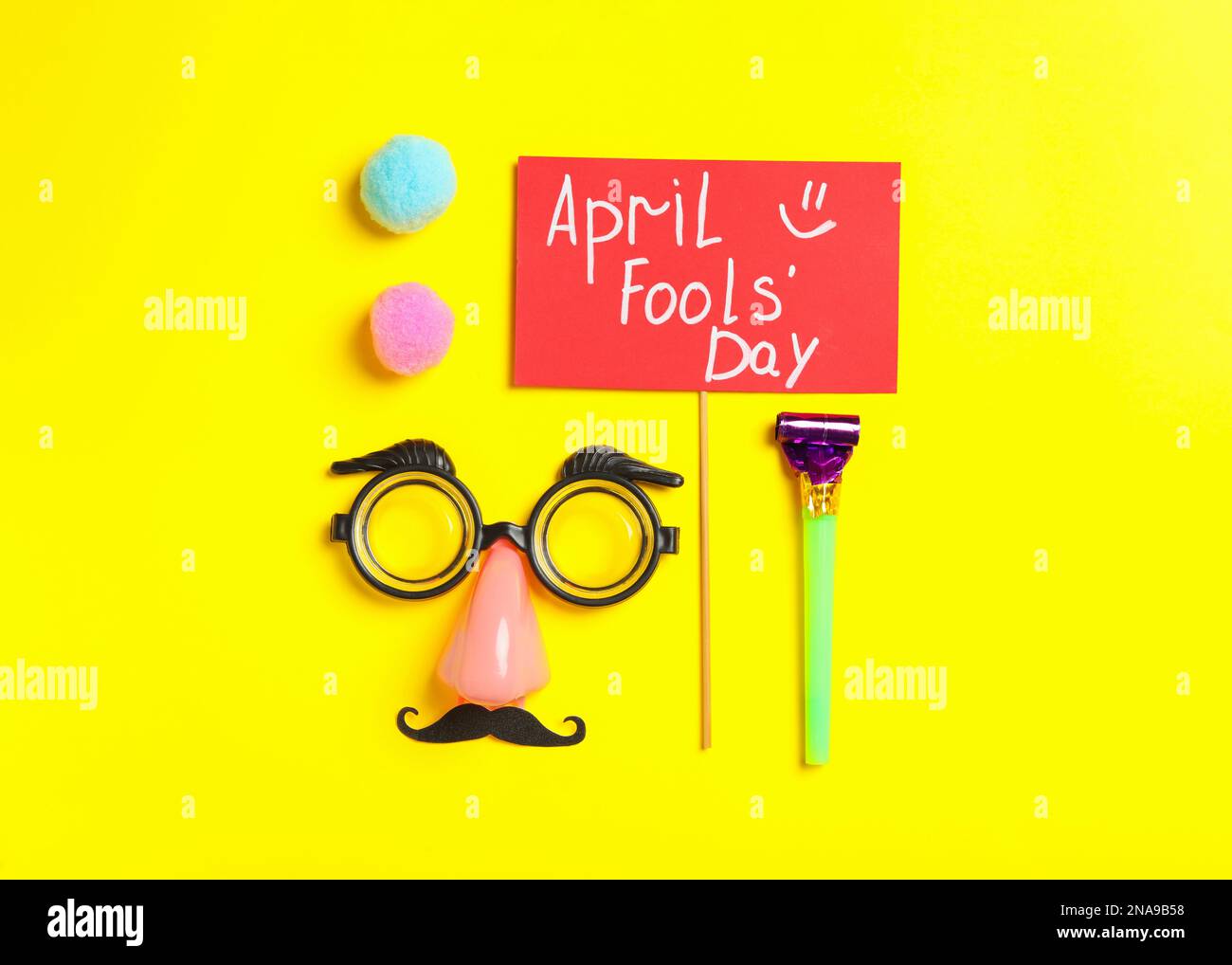 Sign with phrase April Fools' Day and different clown's accessories on ...