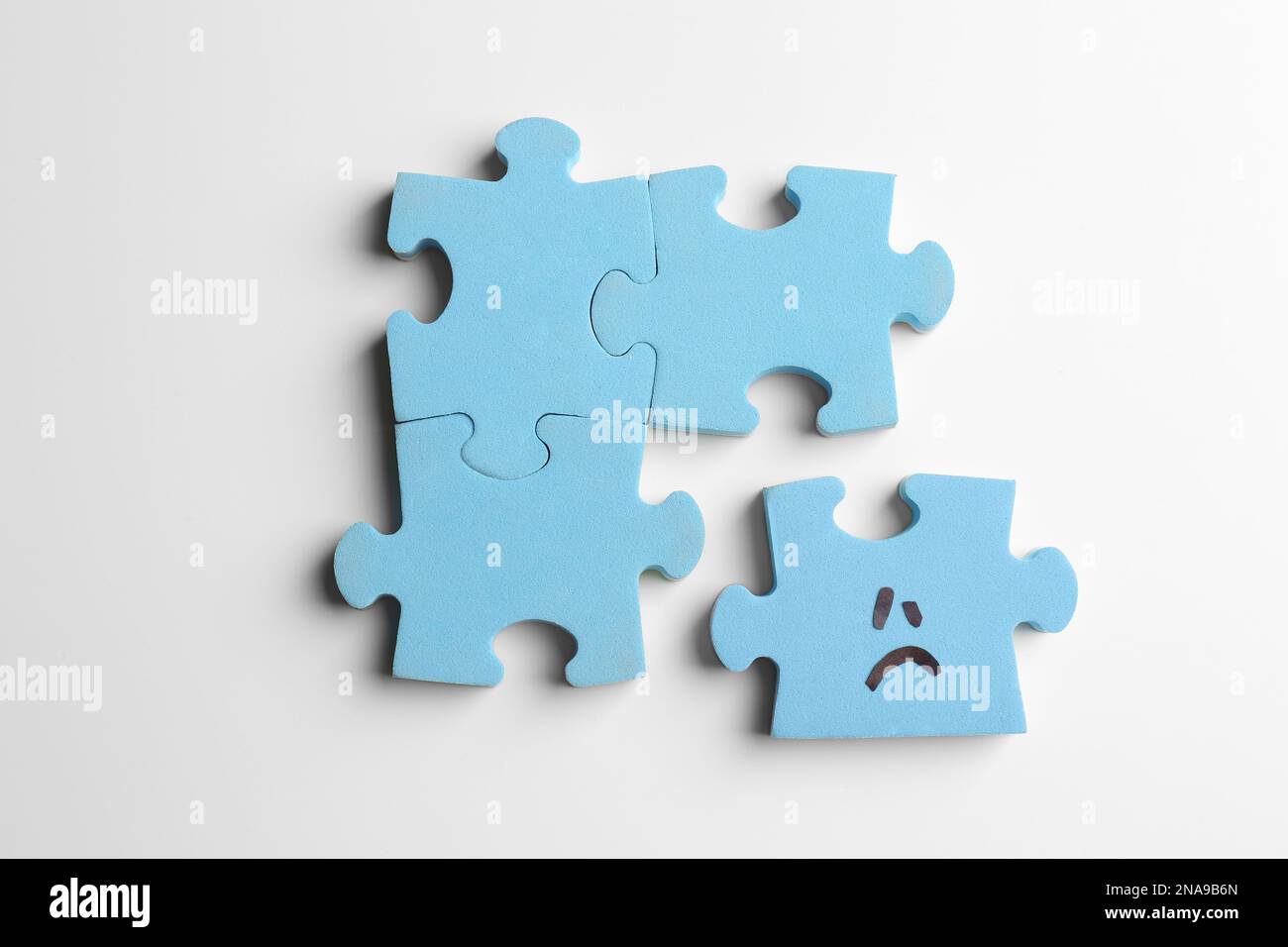 Puzzles with sad face on white background, flat lay Stock Photo - Alamy