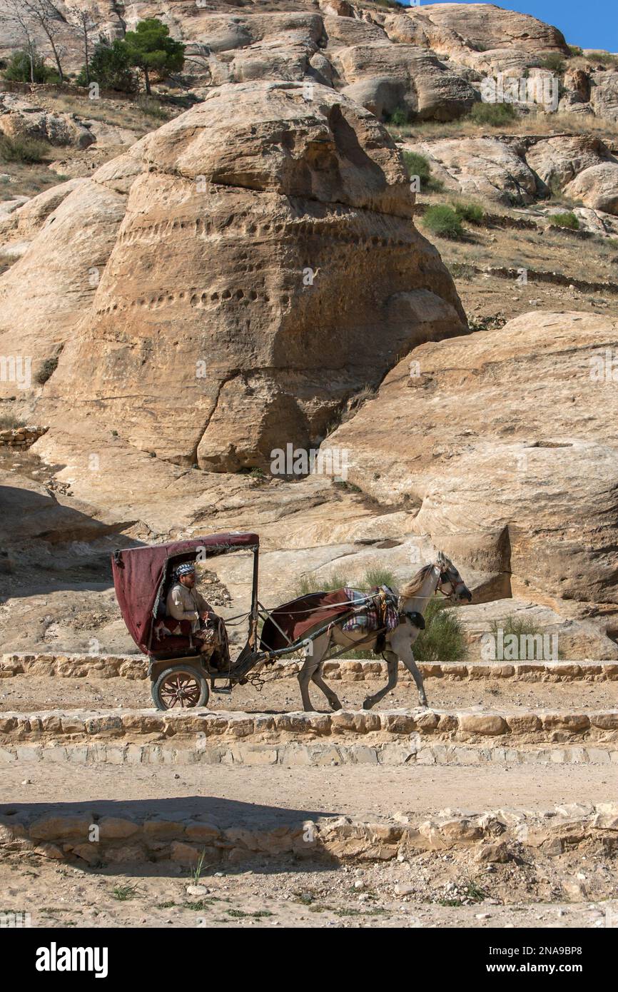 A horse drawn buggy moves through the ancient site of Petra in Jordan ...