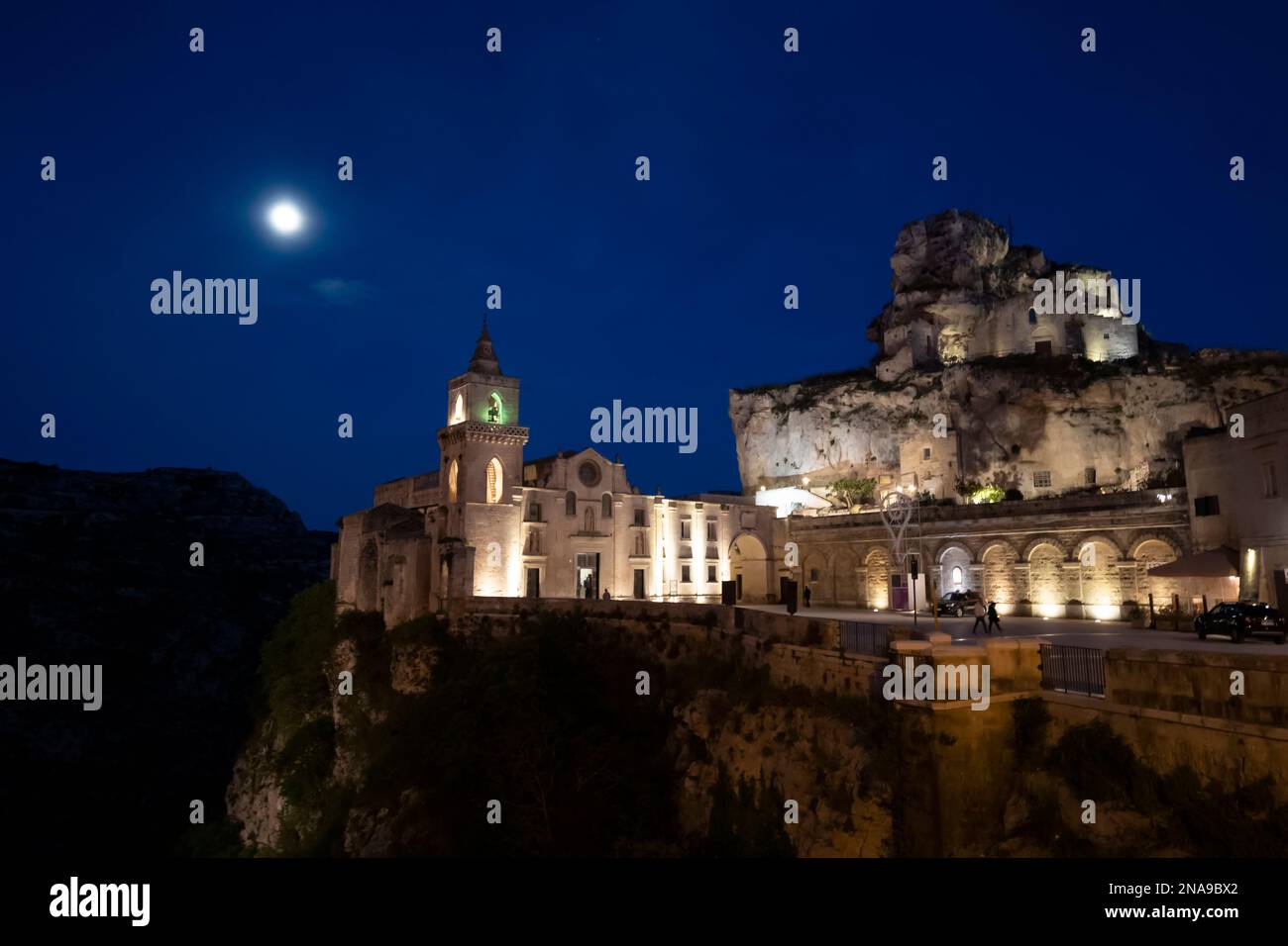 Full moon rising over the ancient cave dwellings and church of the ...