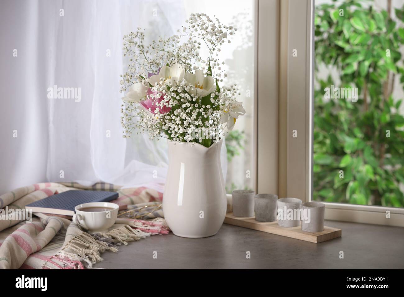 Beautiful fresh flowers on window sill indoors Stock Photo - Alamy