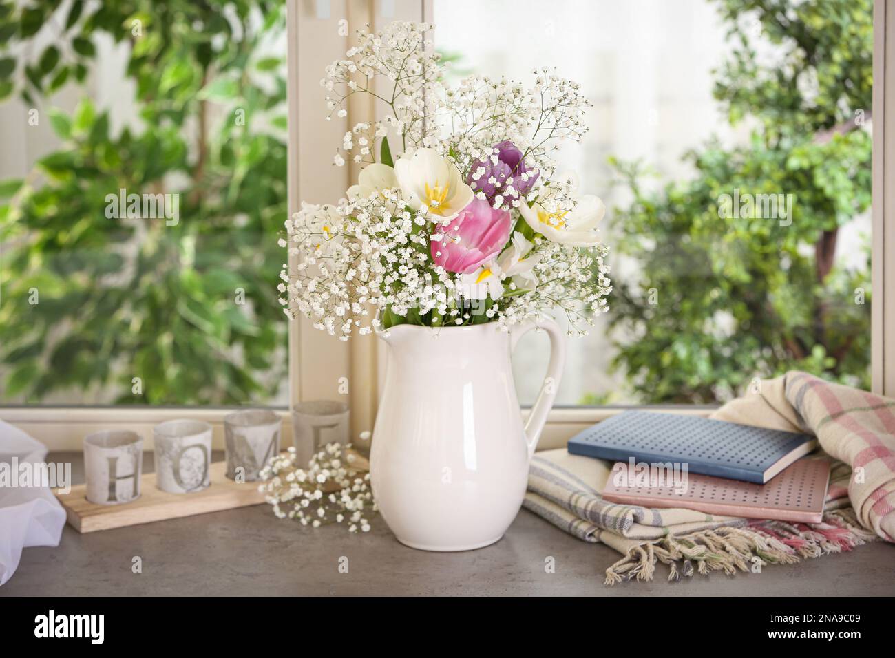 Beautiful fresh flowers on window sill indoors Stock Photo - Alamy