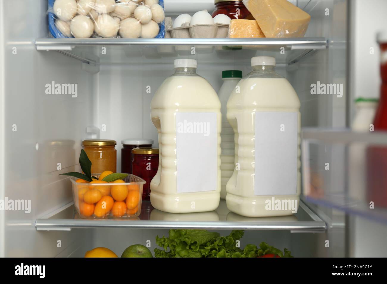 Gallons of milk and different products in refrigerator, closeup Stock ...