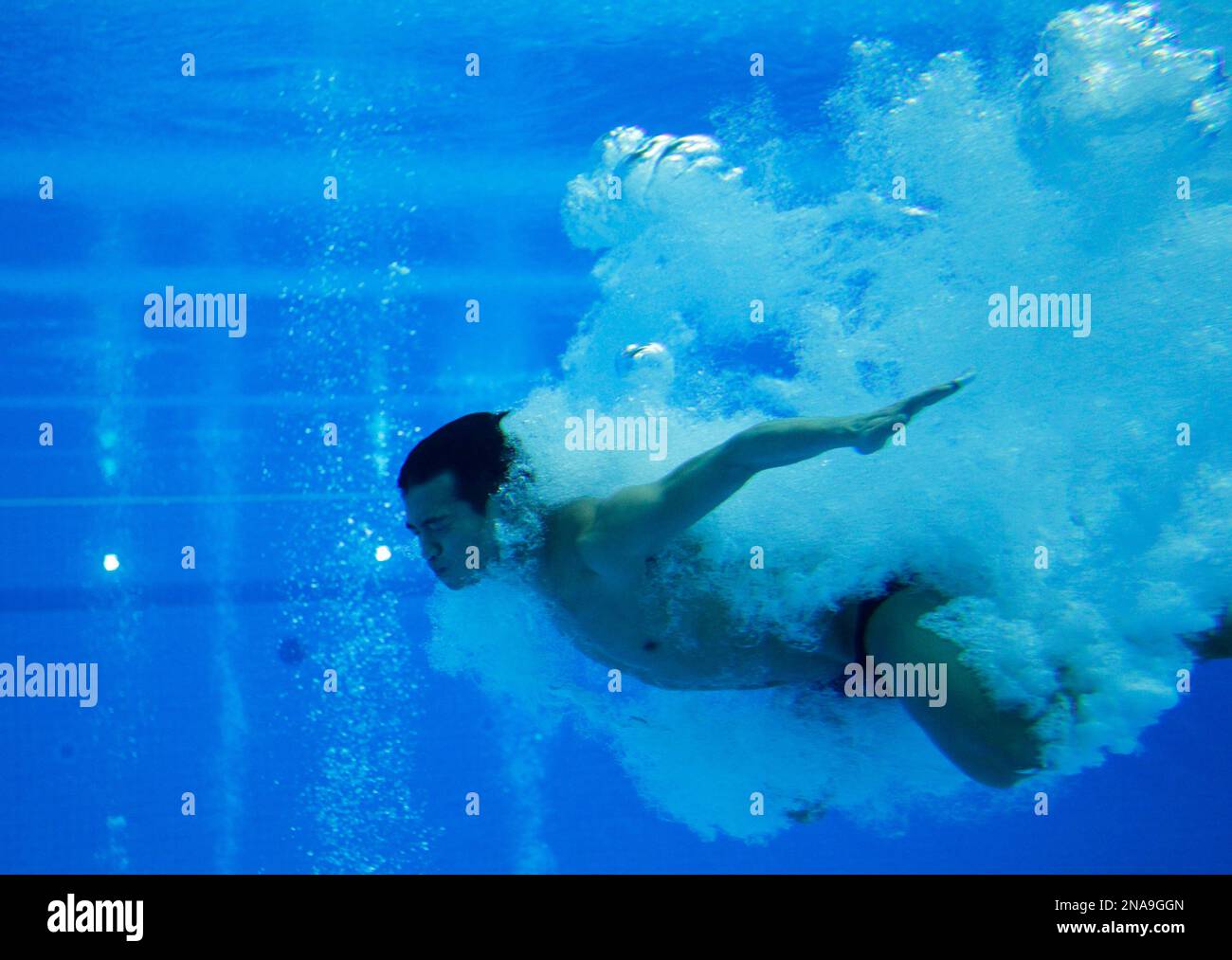 China's He Chong is seen through the glass of a viewing window as he ...