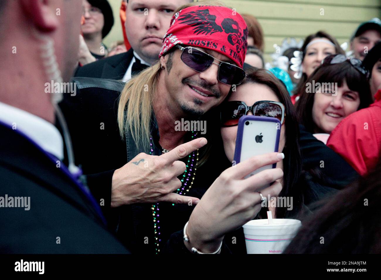 Entertainer Bret Michaels poses for a photograph with a fan as he ...