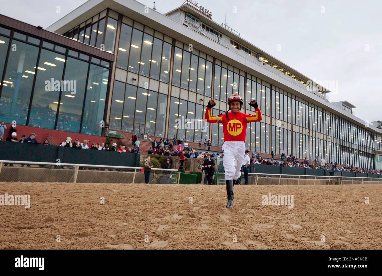 Jockey Rafael Bejarano runs across the track after winning both ...