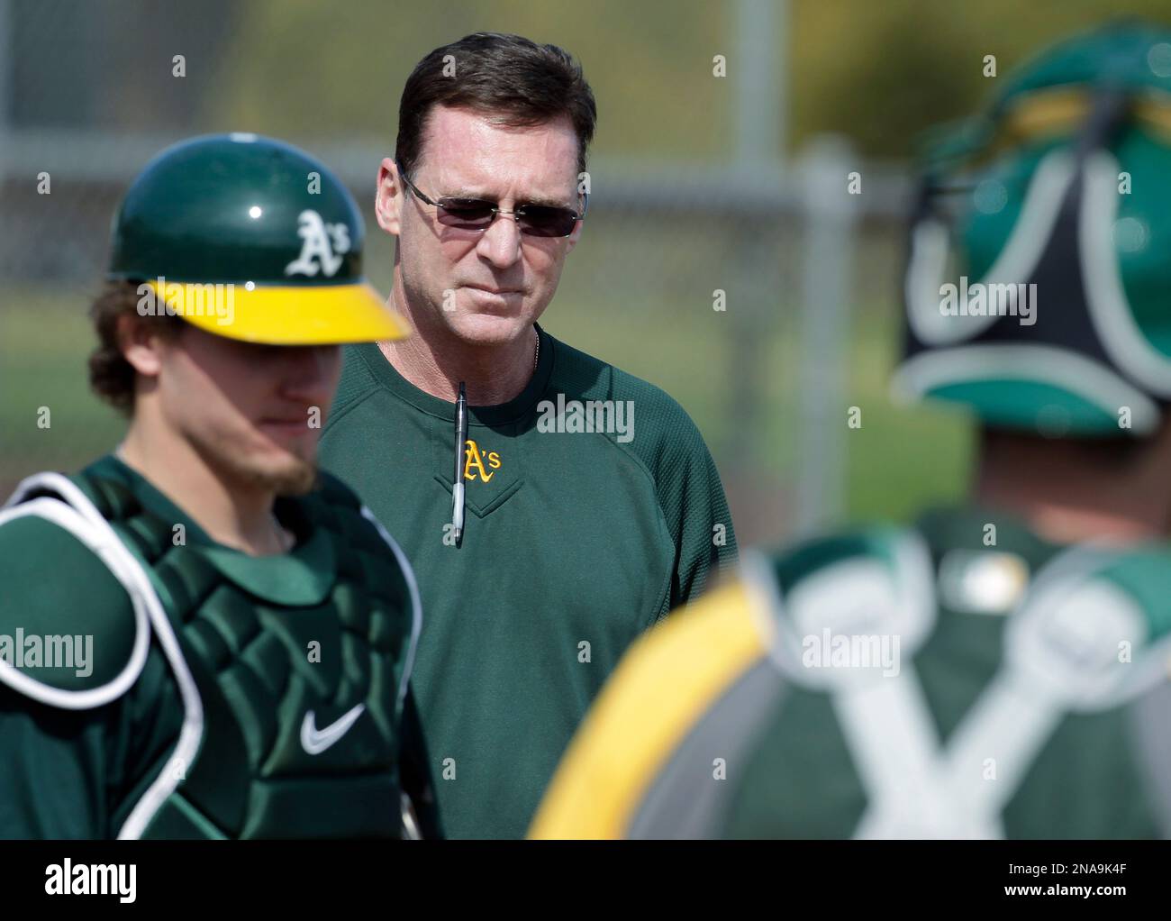 Oakland Athletics manager Bob Melvin talks to catchers during a ...