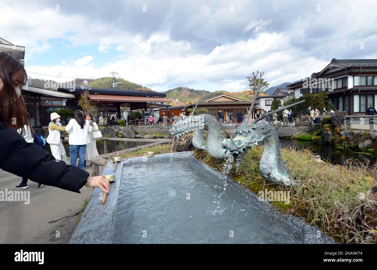 Spring water from dragon ornament tap in Oshino Hakka springs ...