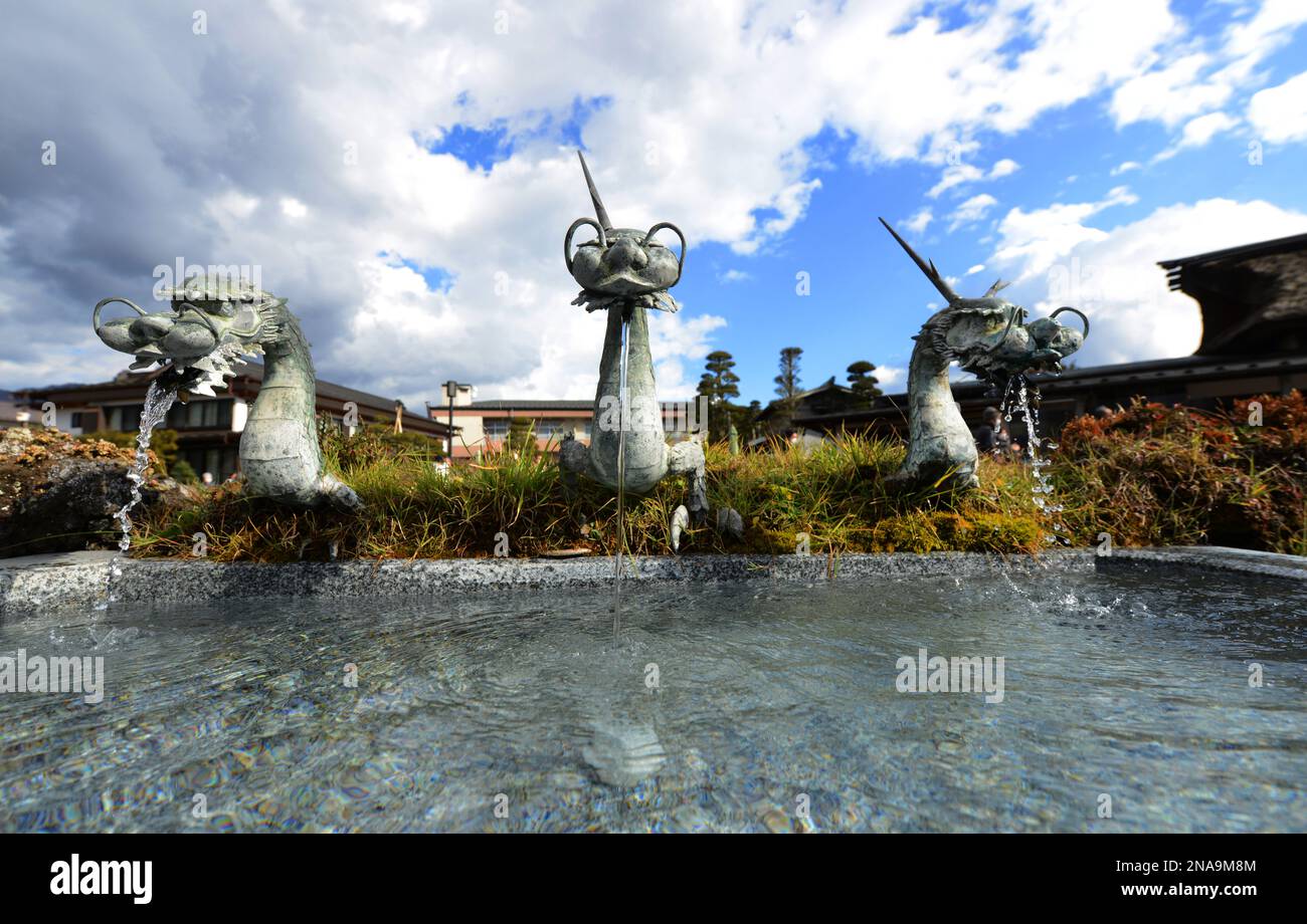 Spring water from dragon ornament tap in Oshino Hakka springs ...