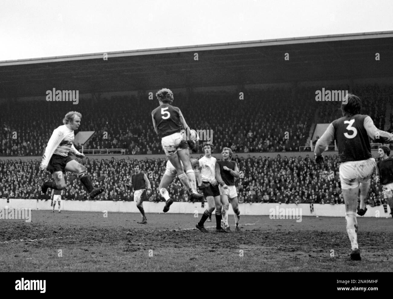 Soccer club West Ham's number 5, Tommy Taylor, shields his goalkeeper ...