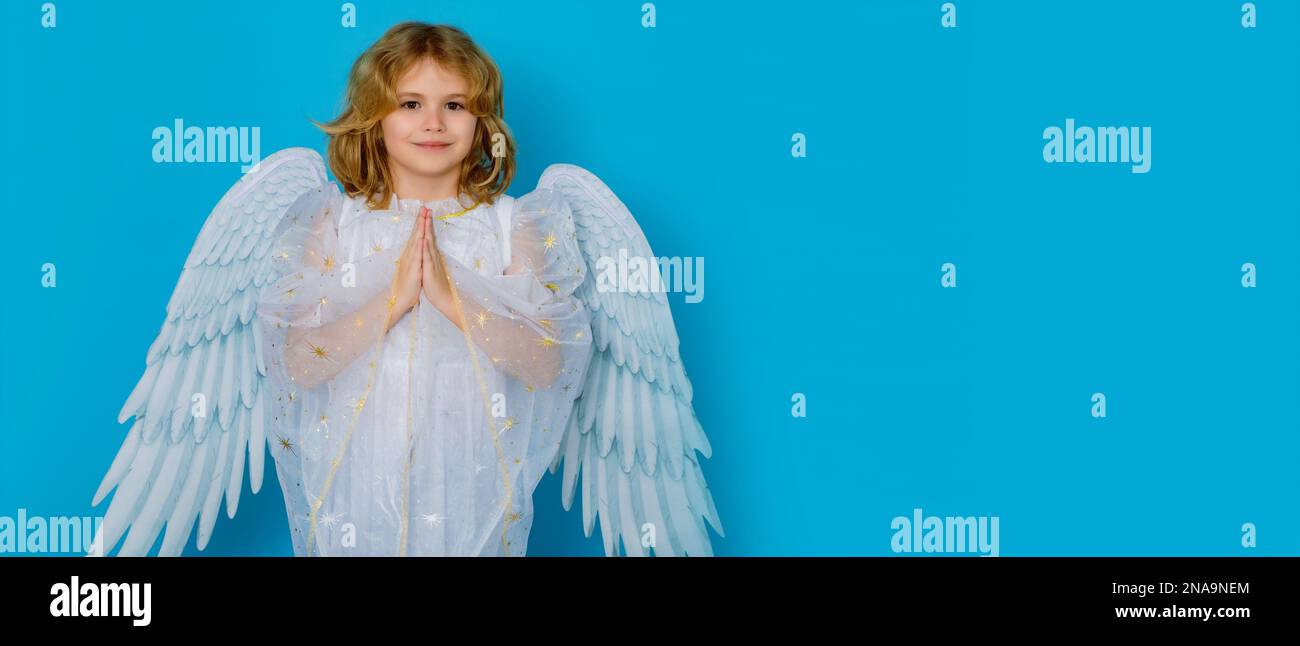 Angel prayer. Valentine's day. Blonde cute child with angel wings on a ...