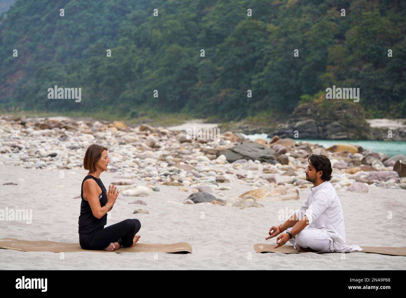 Yoga Class on the bank of the River Ganges flowing through the ...