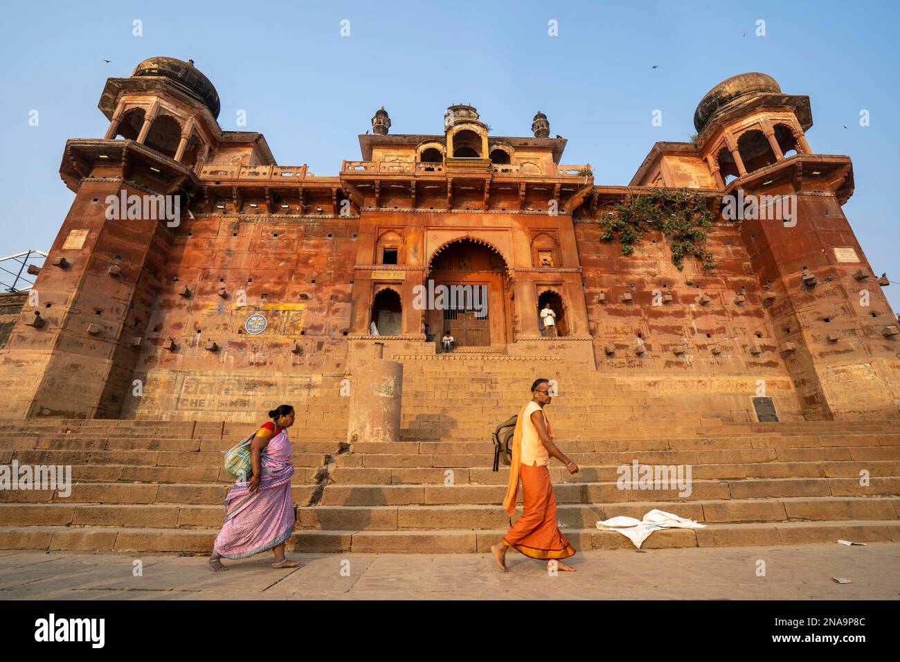 Pilgrims passing the Chet Singh Fort, Varanasi ghats on the banks of ...