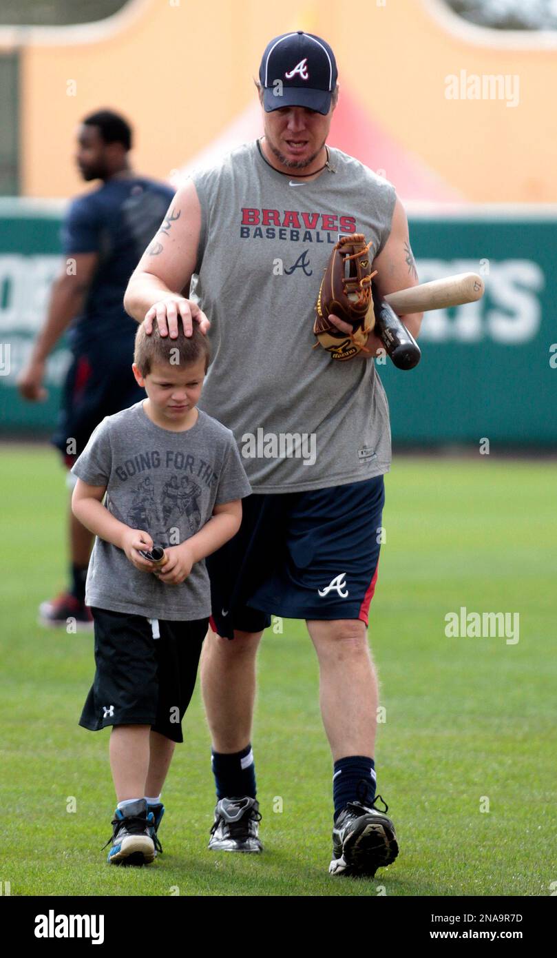 Atlanta Braves' Chipper Jones, right, walks with his son Shea, 7 ...