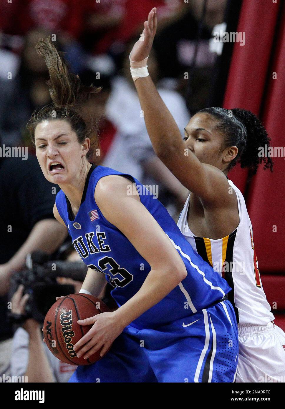 Duke guard Haley Peters, left, attempts to drive past Maryland forward ...