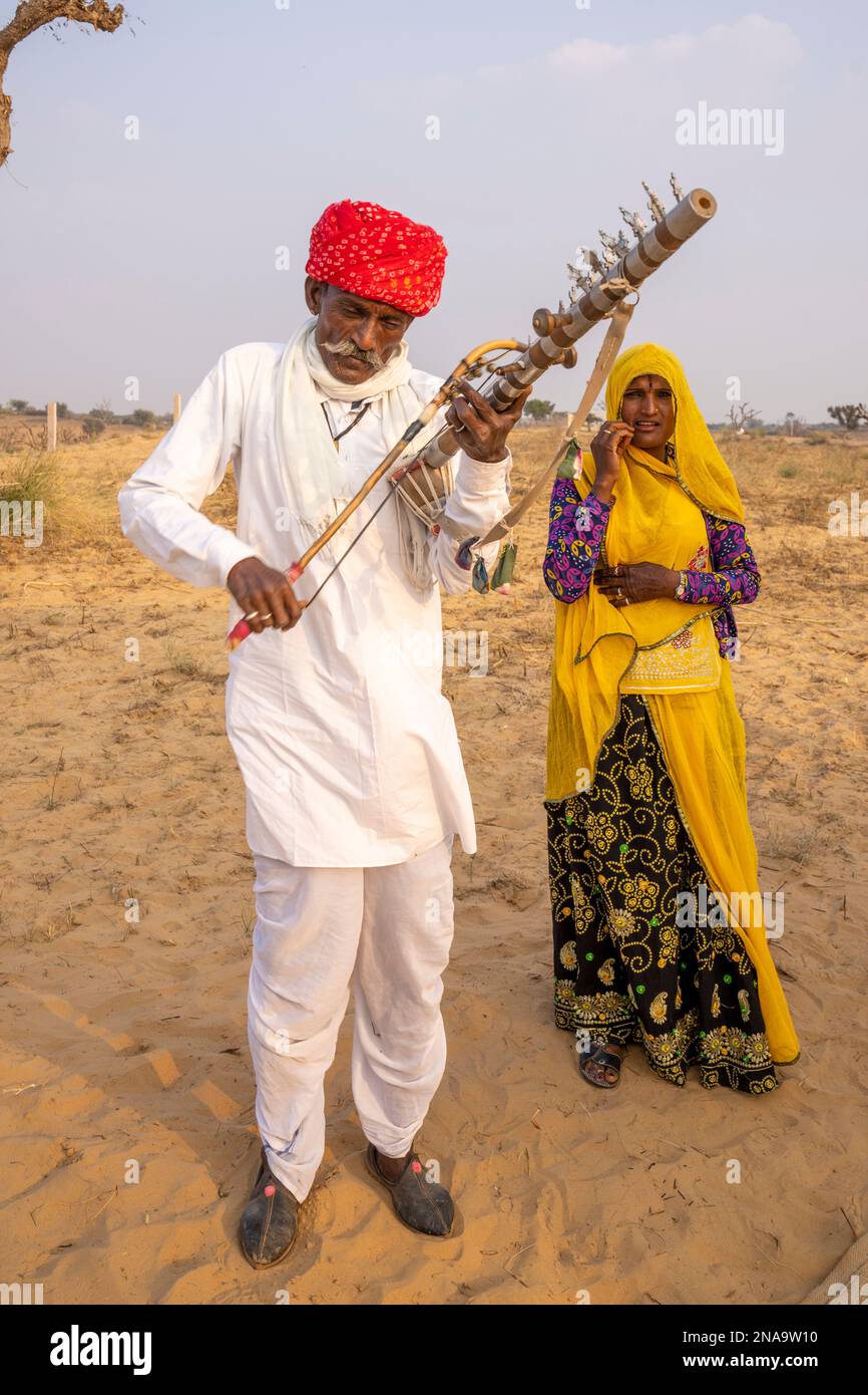 Rajput man playing ravanahatha and woman singer musicians performing at ...