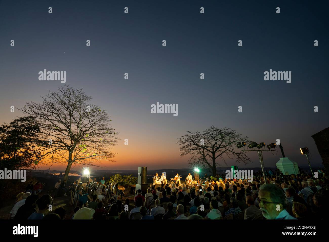Open air music performance at dusk with audience at Church of Our Lady ...