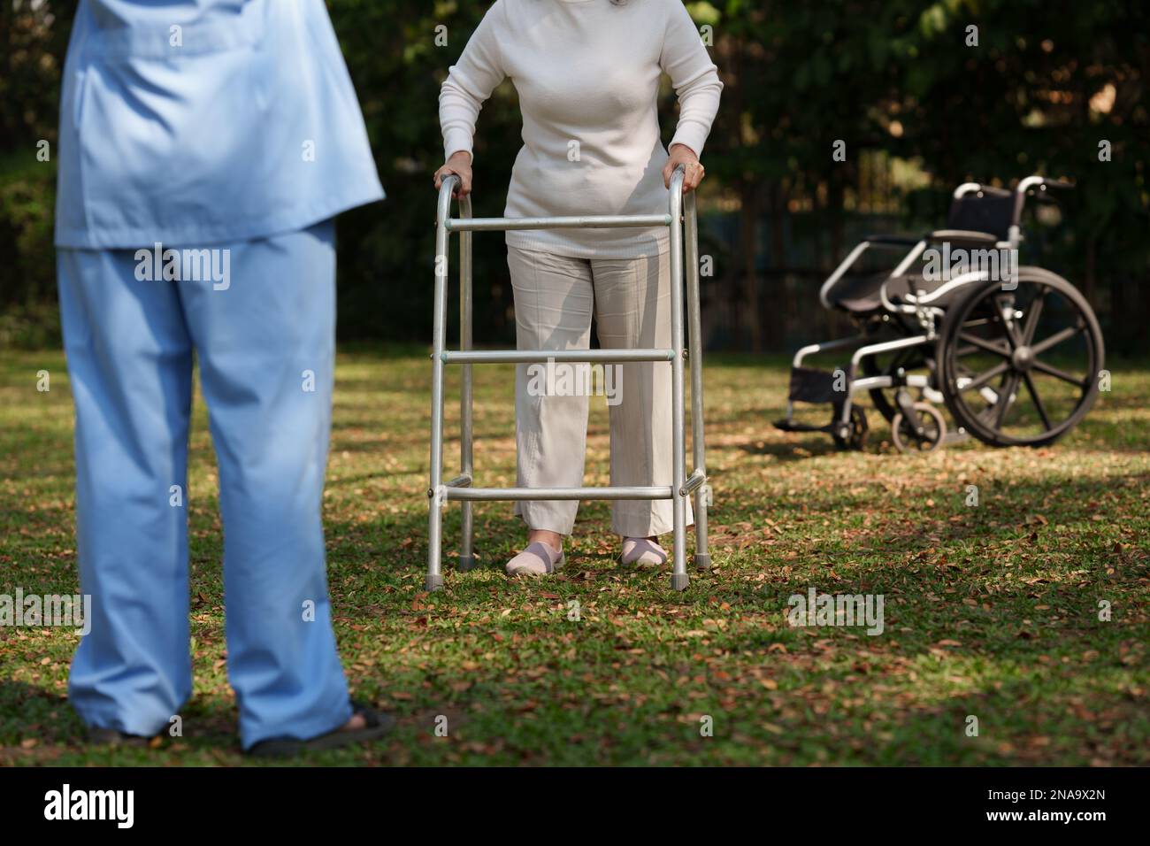 Elderly asian senior woman practice walking with aluminum walker for ...