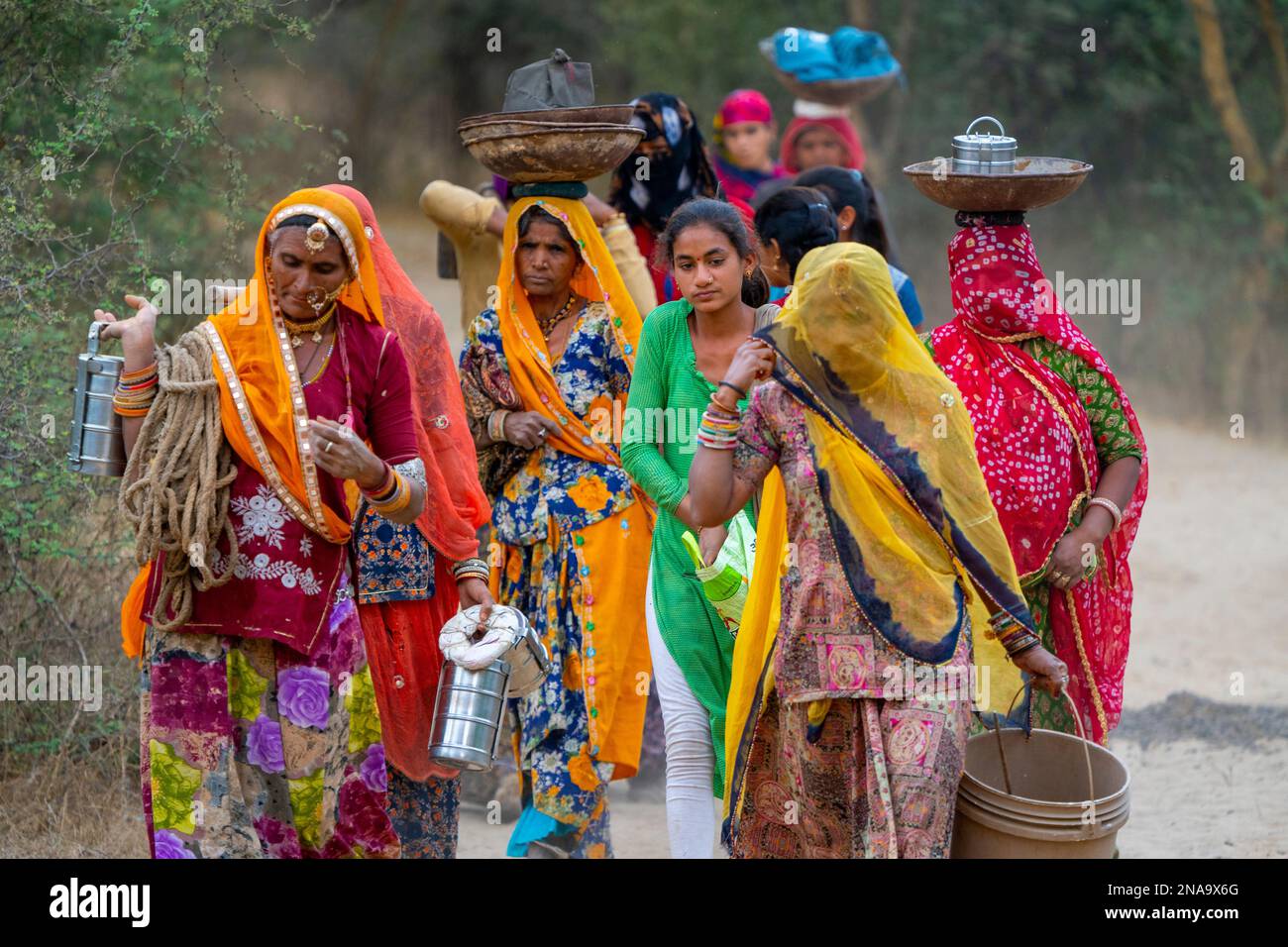 Women returning to village in the rural desert around Nimaj, Jaitaran ...