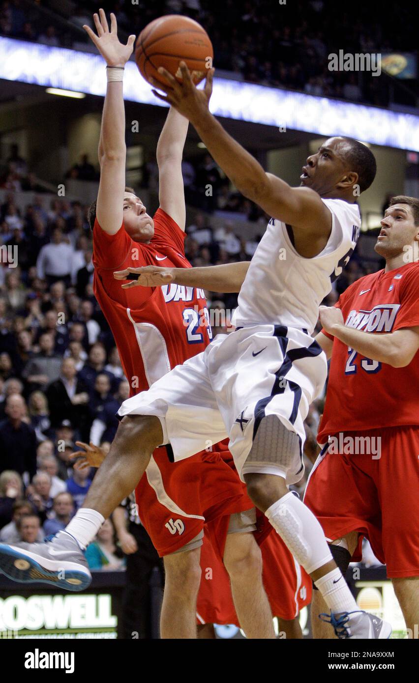 Xavier forward Dezmine Wells, center, shoots between Dayton forward ...
