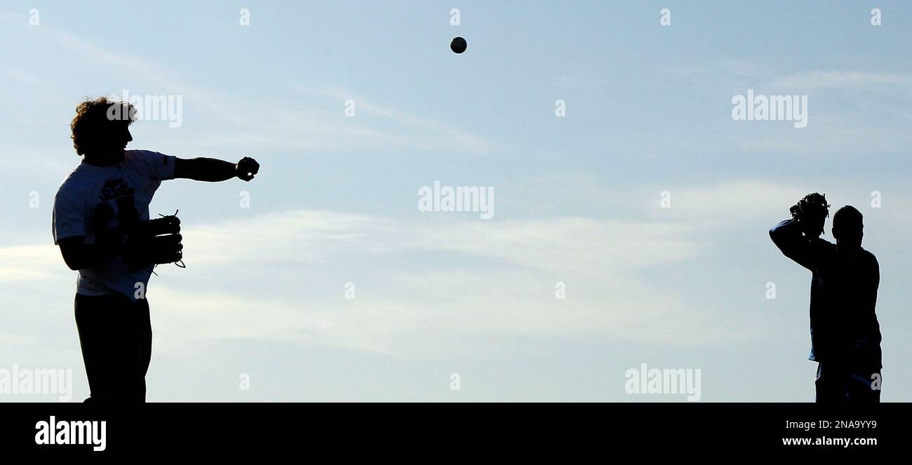 Texas Rangers pitchers Derek Holland, left, and Mike Adams throw during ...