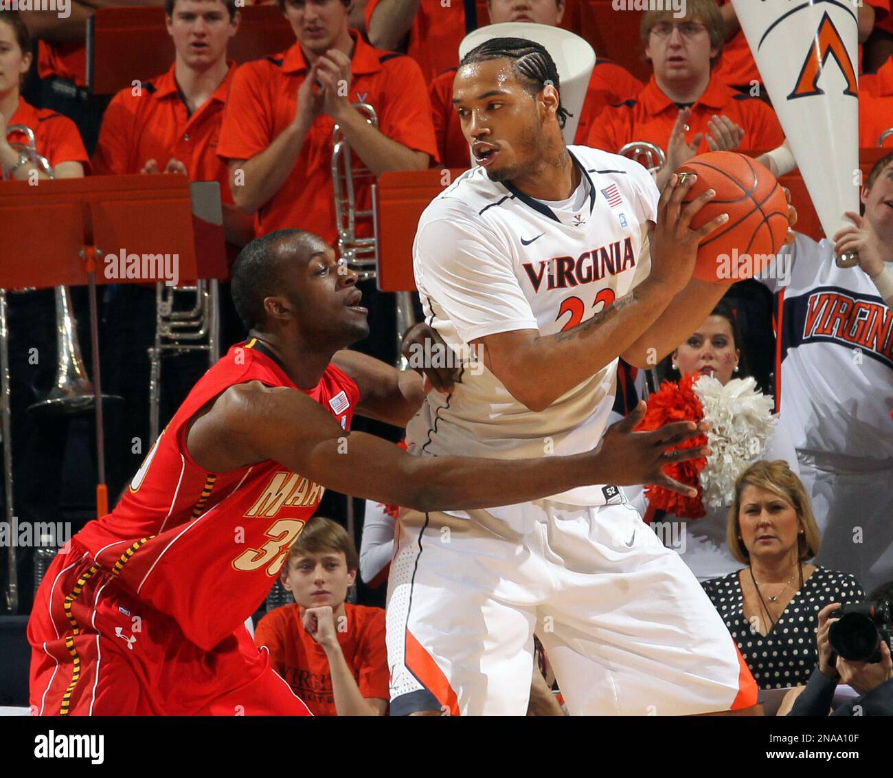 Virginia forward Mike Scott (23) handles the ball next to Maryland ...
