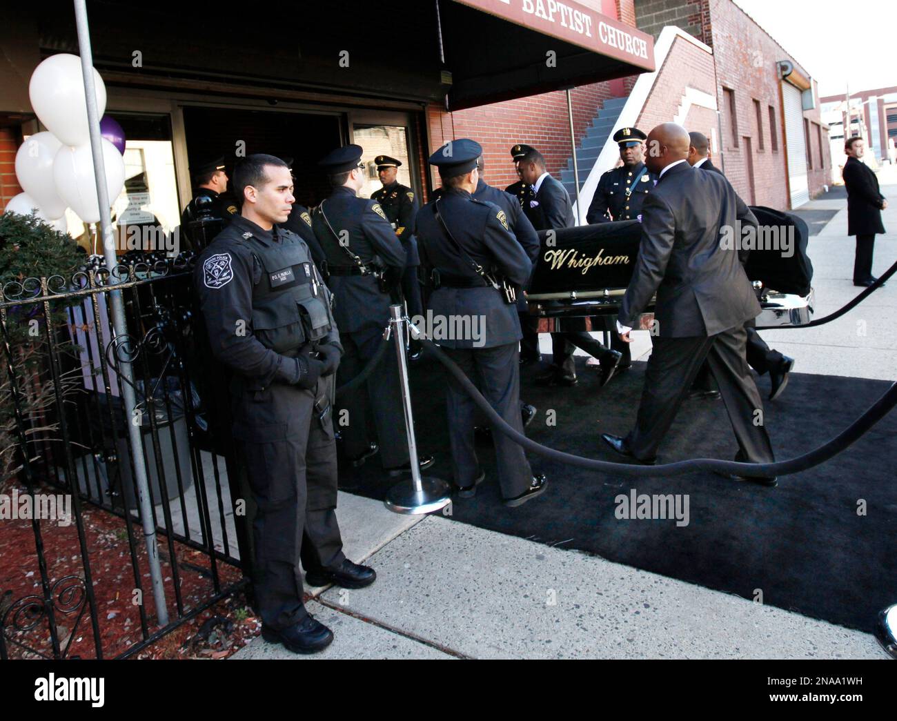 A coffin holding the remains of singer Whitney Houston is carried into ...