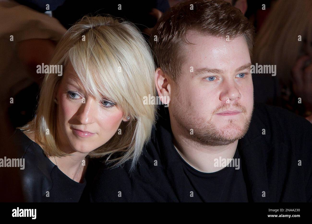 From left Julia Carey and James Corden watch models display creations ...