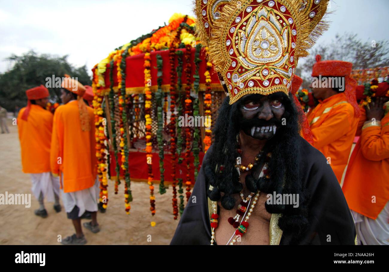 A Hindu devotee dressed as a demon participates in a procession ahead ...