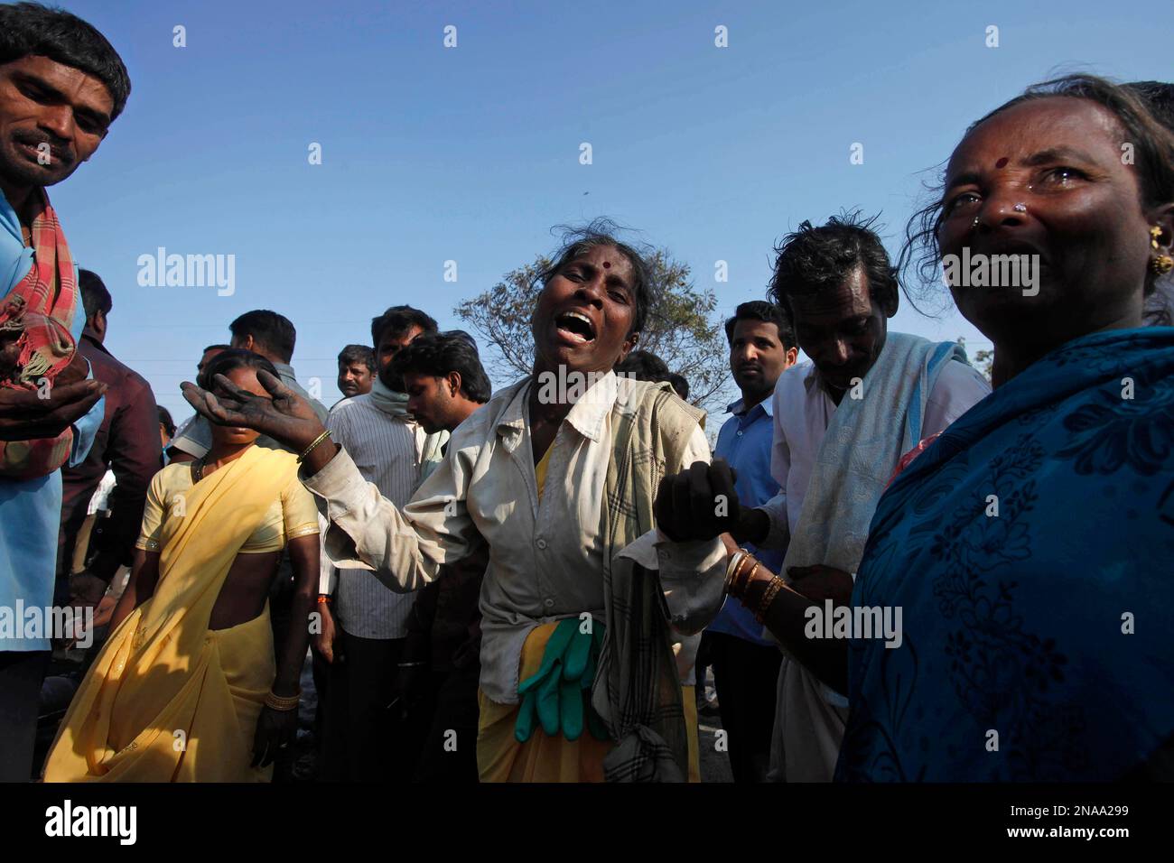 An Indian woman mourns the death of her relative, a victim of a fire ...