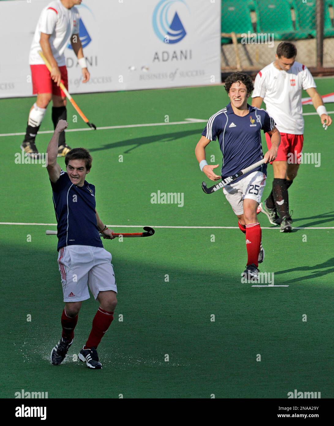 French hockey player Hugo Genestet, in blue jersey, celebrates after ...