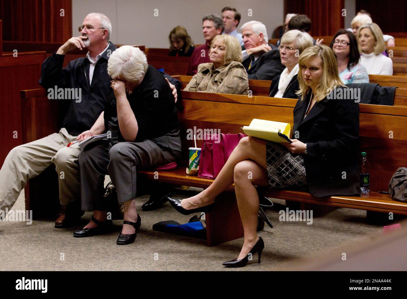 Glenda Watson, second from left, is hugged by her husband David Watson ...