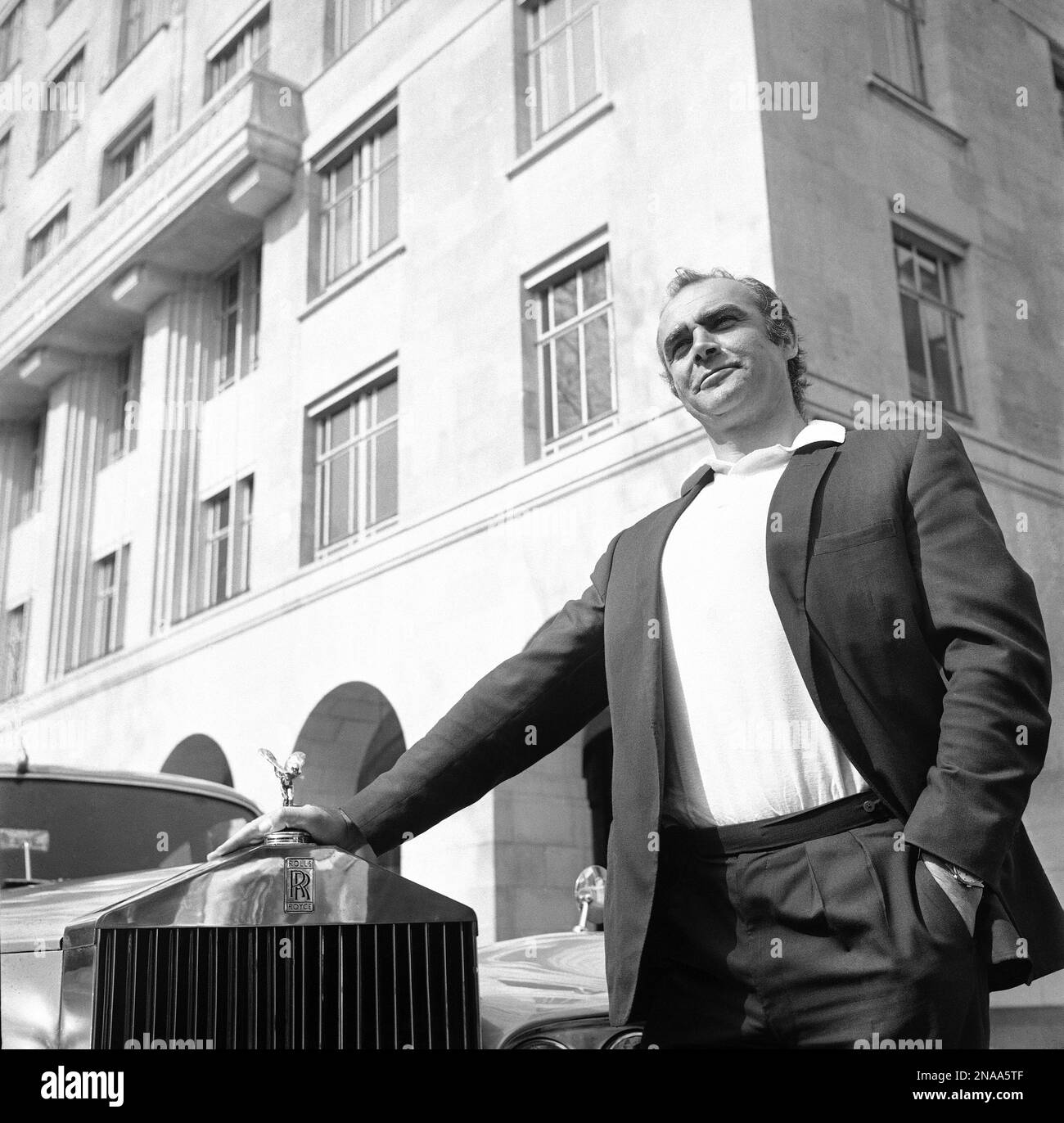 Scottish actor Sean Connery, 40, rests a hand on his Rolls Royce at the ...