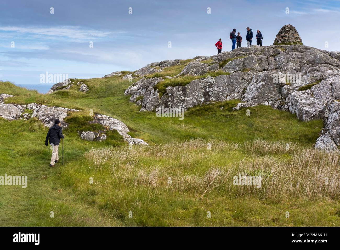 Hikers follow a foot path on Dun I, Isle of Iona, Scotland Stock Photo ...