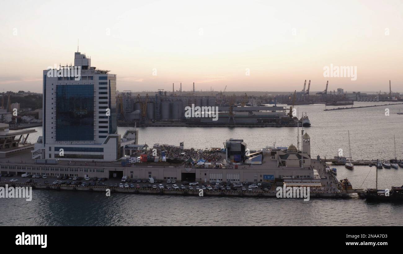 Evening scape of Odessa hotel on the sea port. Parking and yacht docks ...