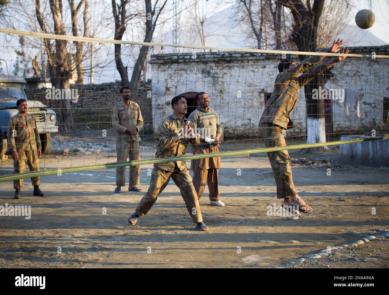 Pakistani army soldiers play volleyball at their base in Temagara ...