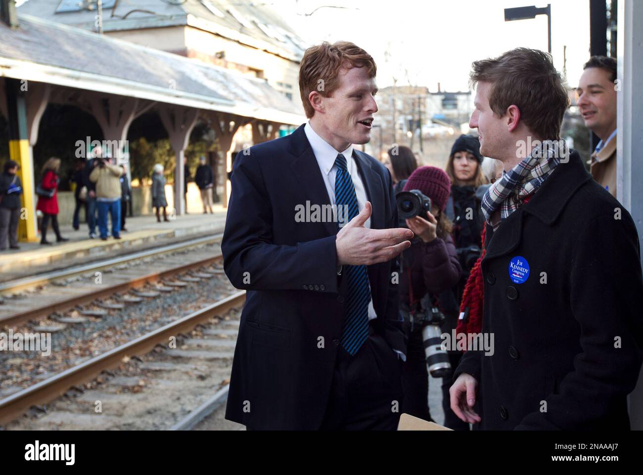Joseph Kennedy III, center, greets people at the Newton Center Green ...
