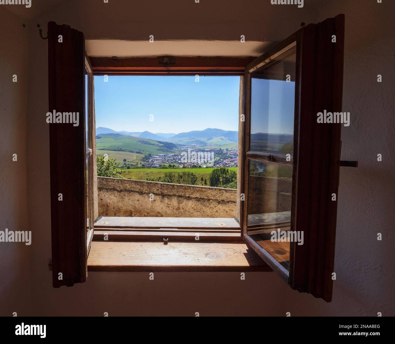 view from the open old wooden window. hills rolling in to the distant ...
