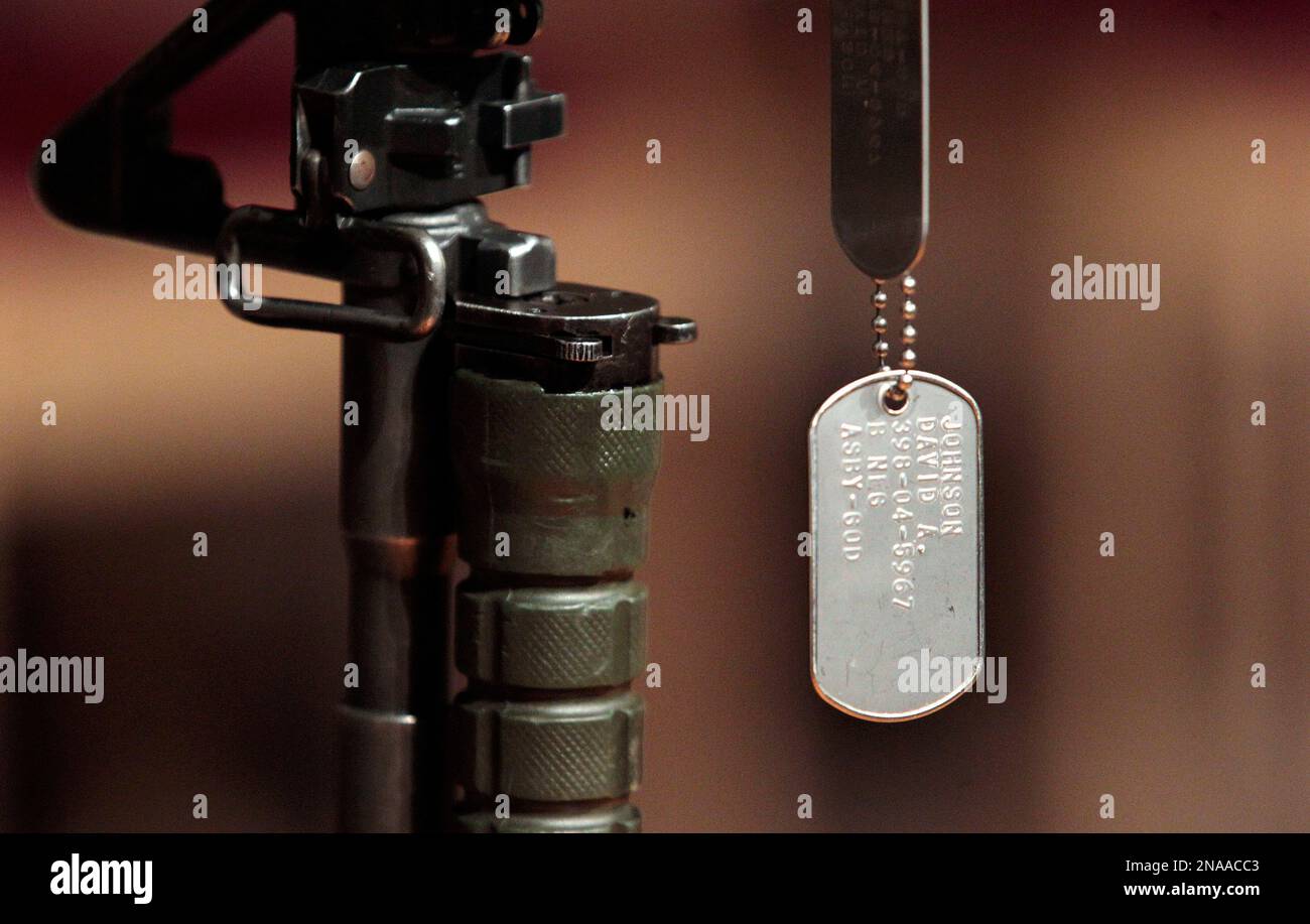 The dog tags of 1st Lt. David A. Johnson hang from a ceremonial rifle ...