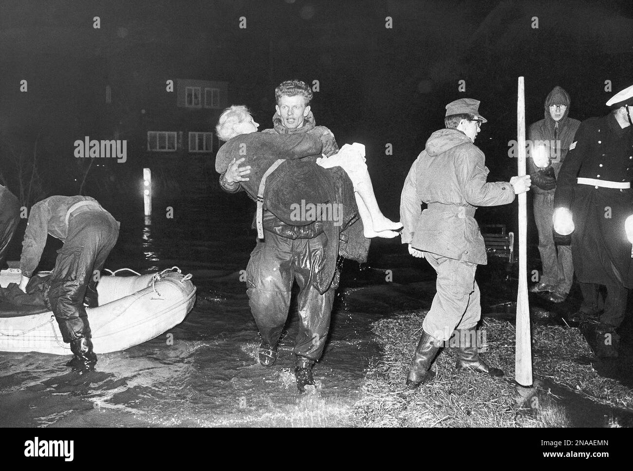 A soldier of the West German Army (Bundeswehr) carries a woman to ...