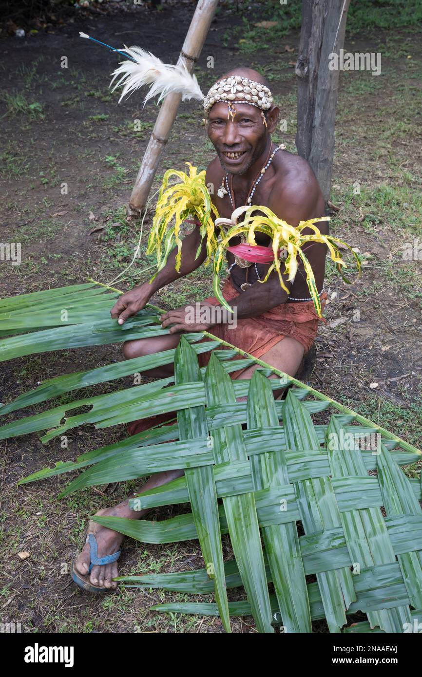 Village men weaving palm leaves in Madang, Papua New Guinea Stock Photo ...