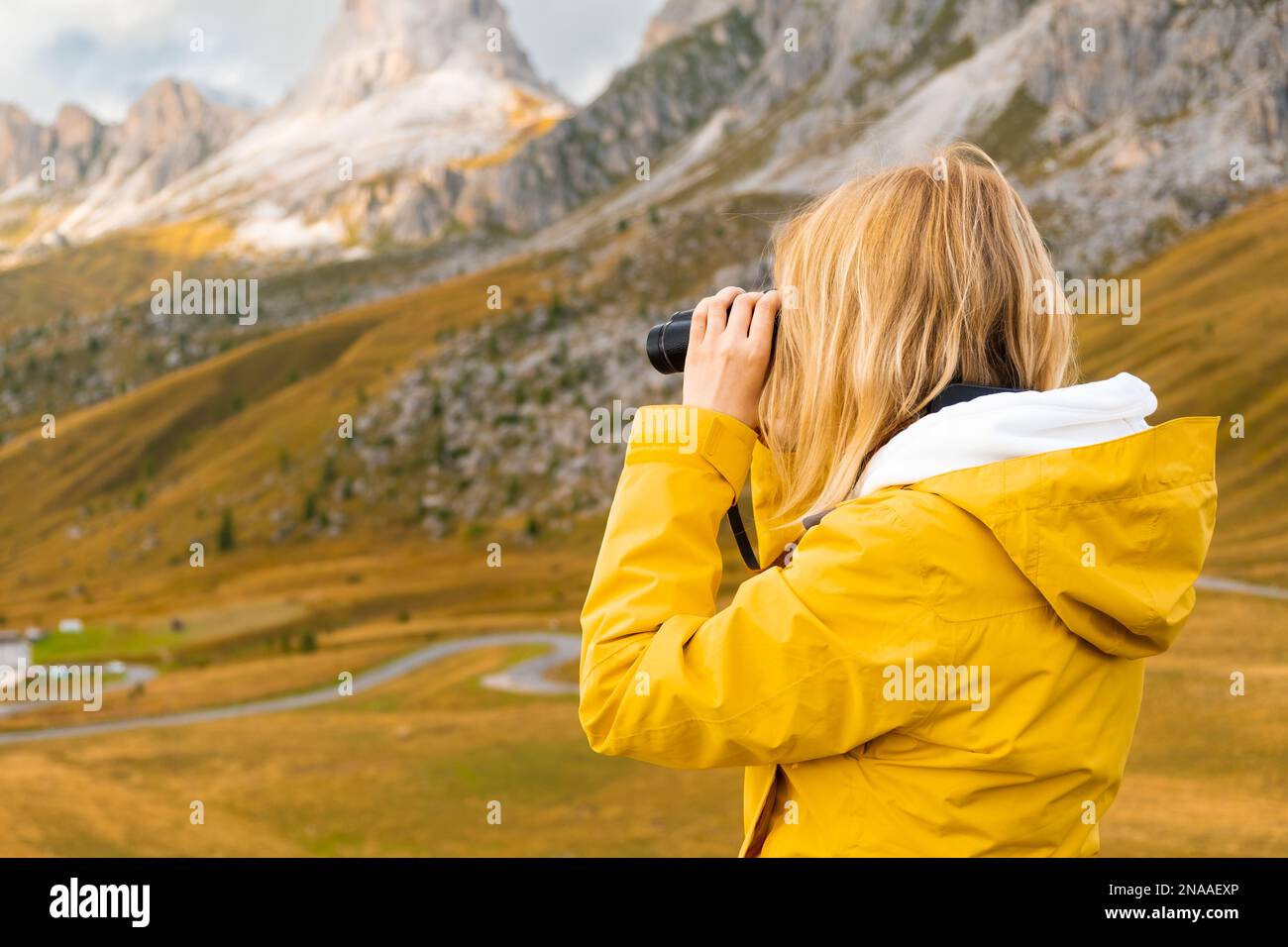 Woman traveling exploring the mountains views covered by clouds looking ...
