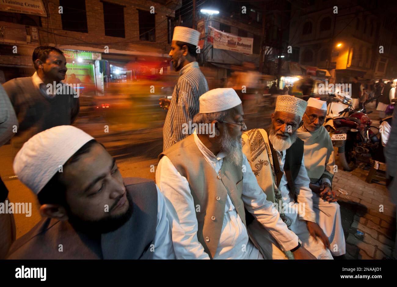 Indian Muslim men sit in Varanasi, India, Tuesday, Feb. 14, 2012 ...