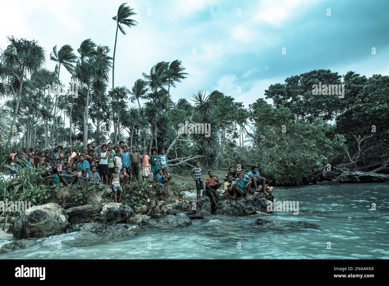 Children gathered on the shore of Tuam Island of the Siassi, Papua New ...