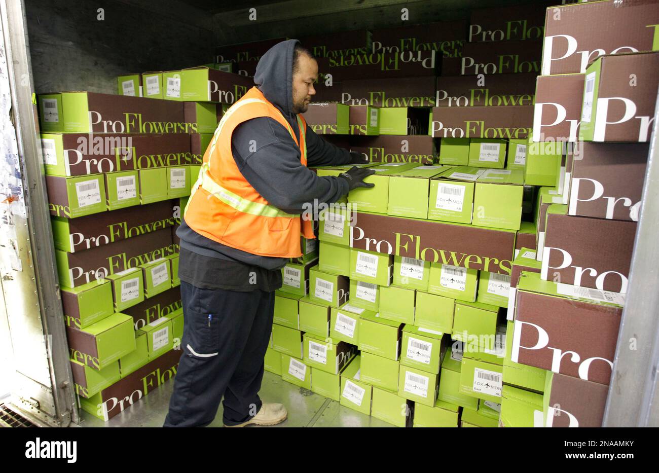 FedEx worker Sid Logoai loads some of about 25,000 boxes of flowers ...