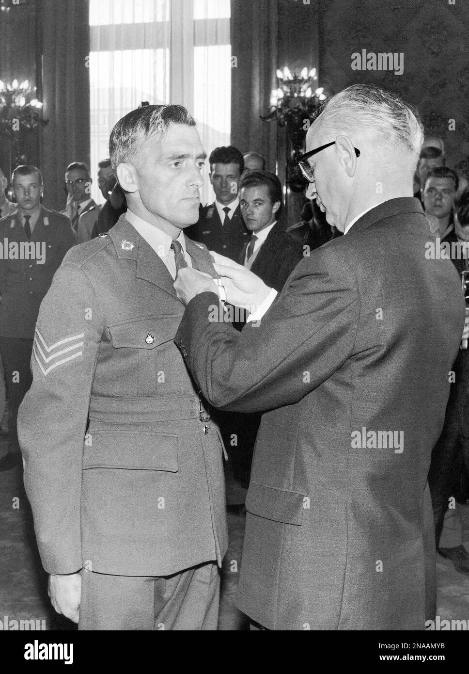 Hamburg Mayor Dr. Paul Nevermann, right, pins a special thank-you medal ...